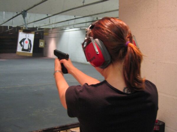 woman-with-handgun-at-indoor-shooting-range - Machine Gun Experience